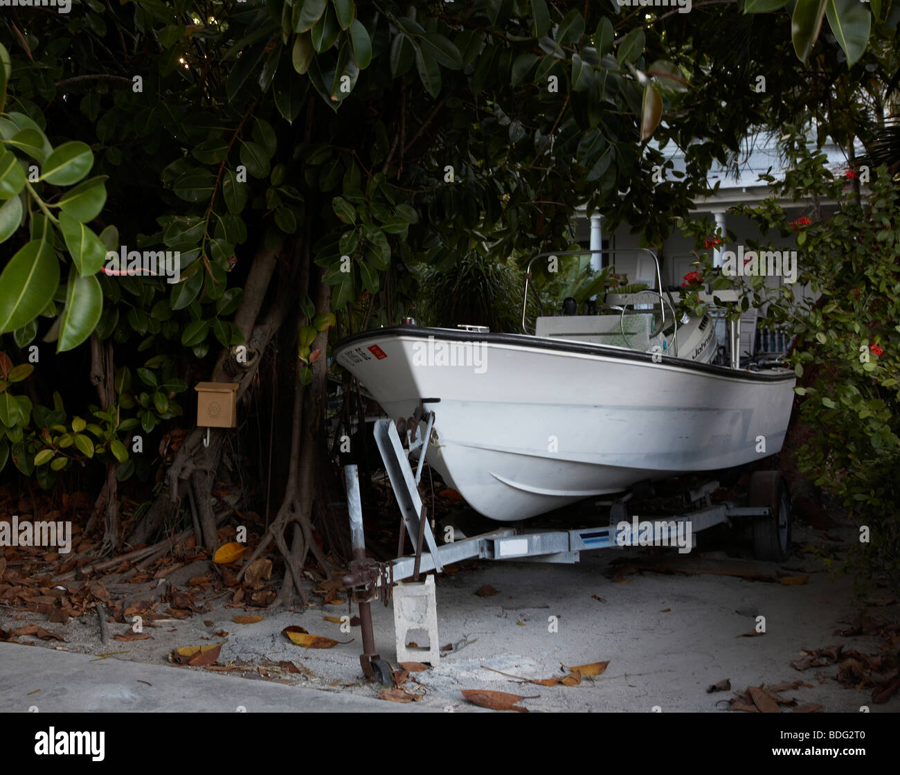boat on trailer under tree Stock Photo - Alamy