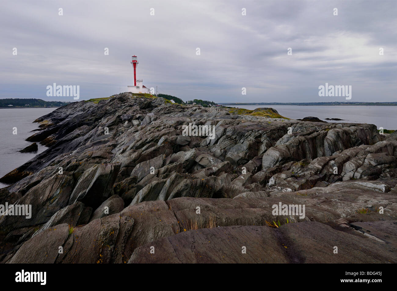 Cape Forchu peninsula and lighthouse on the Atlantic Ocean with wet ...