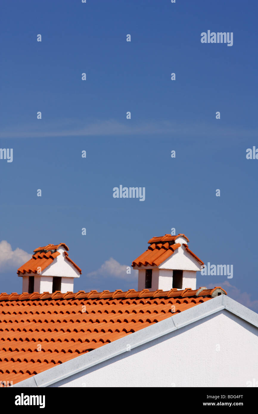 Two chimneys on the roof under the blue sky Stock Photo - Alamy