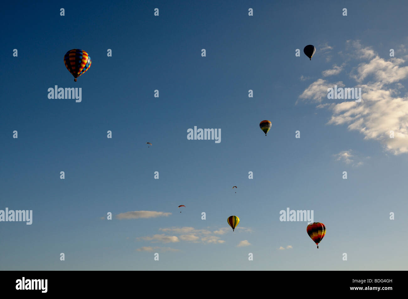 Stock photo of hot air balloons and powered parachutes flying off into ...