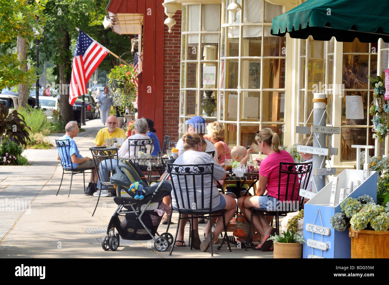 Street scene in Falmouth, Cape Cod with people eating at outdoor tables ...