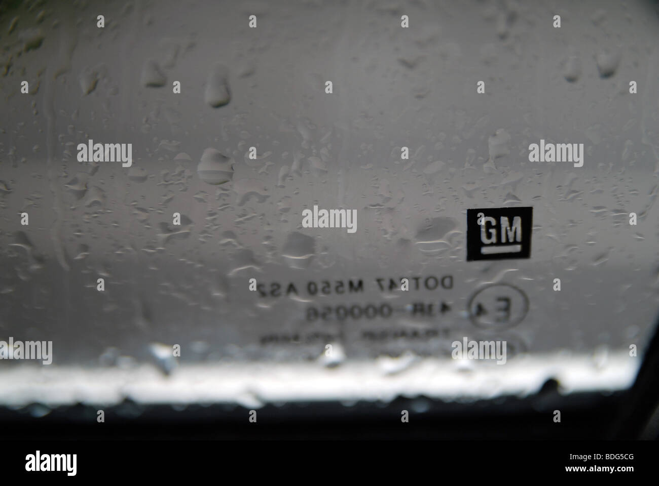 GM - General Motors logo on a car windscreen in the rain Stock Photo ...