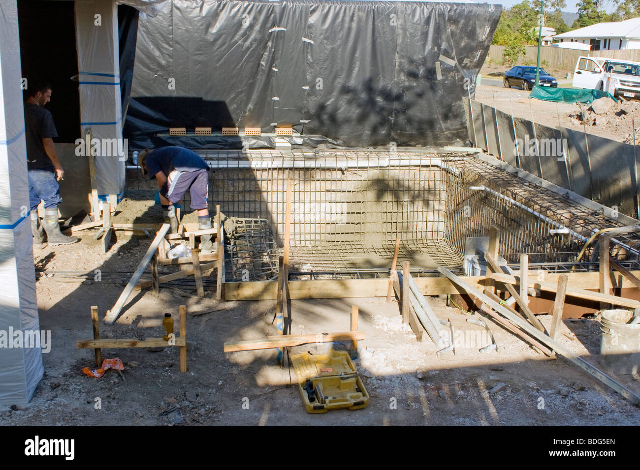 Spraying shotcrete on a new swimming pool Stock Photo - Alamy
