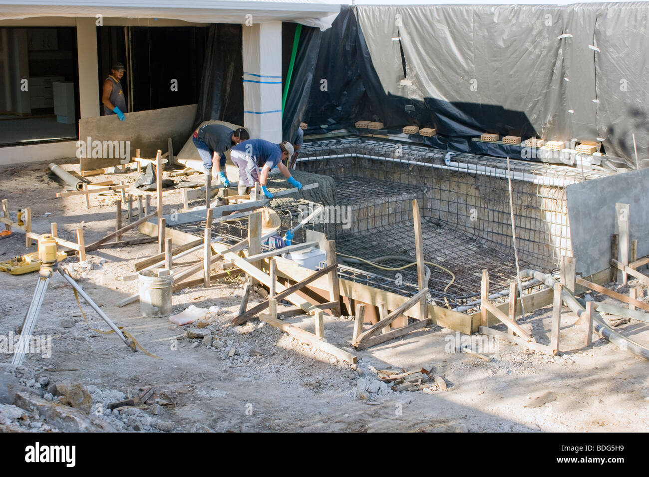Spraying shotcrete on a new swimming pool Stock Photo - Alamy