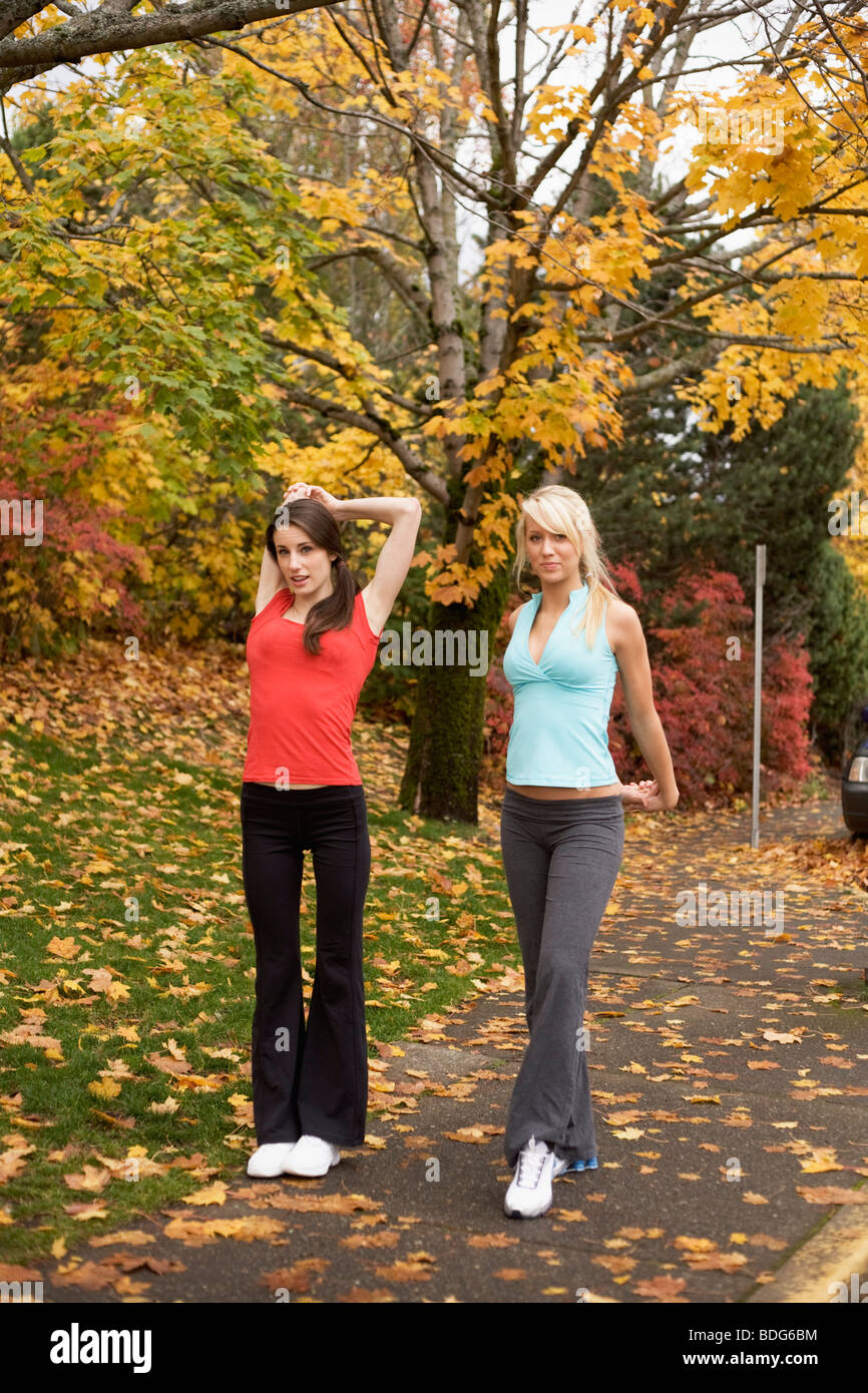 Portrait of two young women stretching their arms during autumn Stock ...
