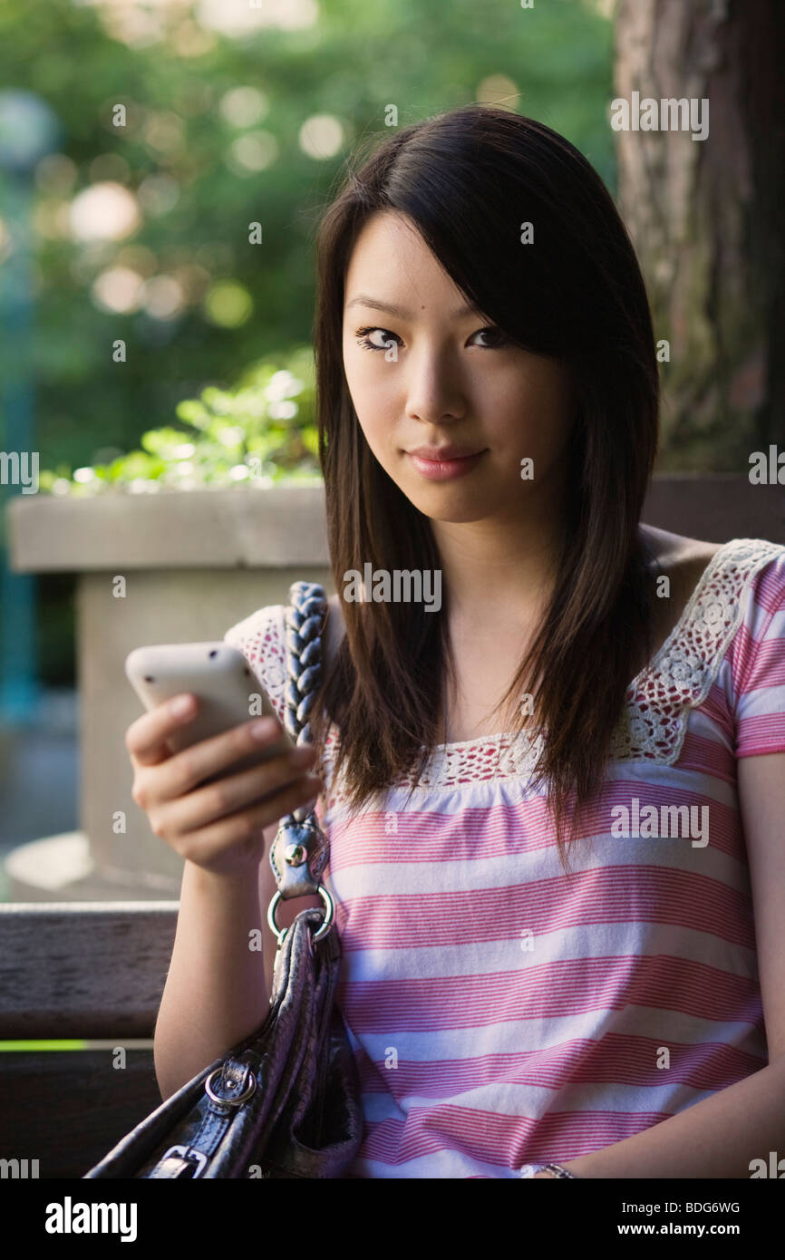 A portrait of a young woman texting on her mobile phone Stock Photo - Alamy