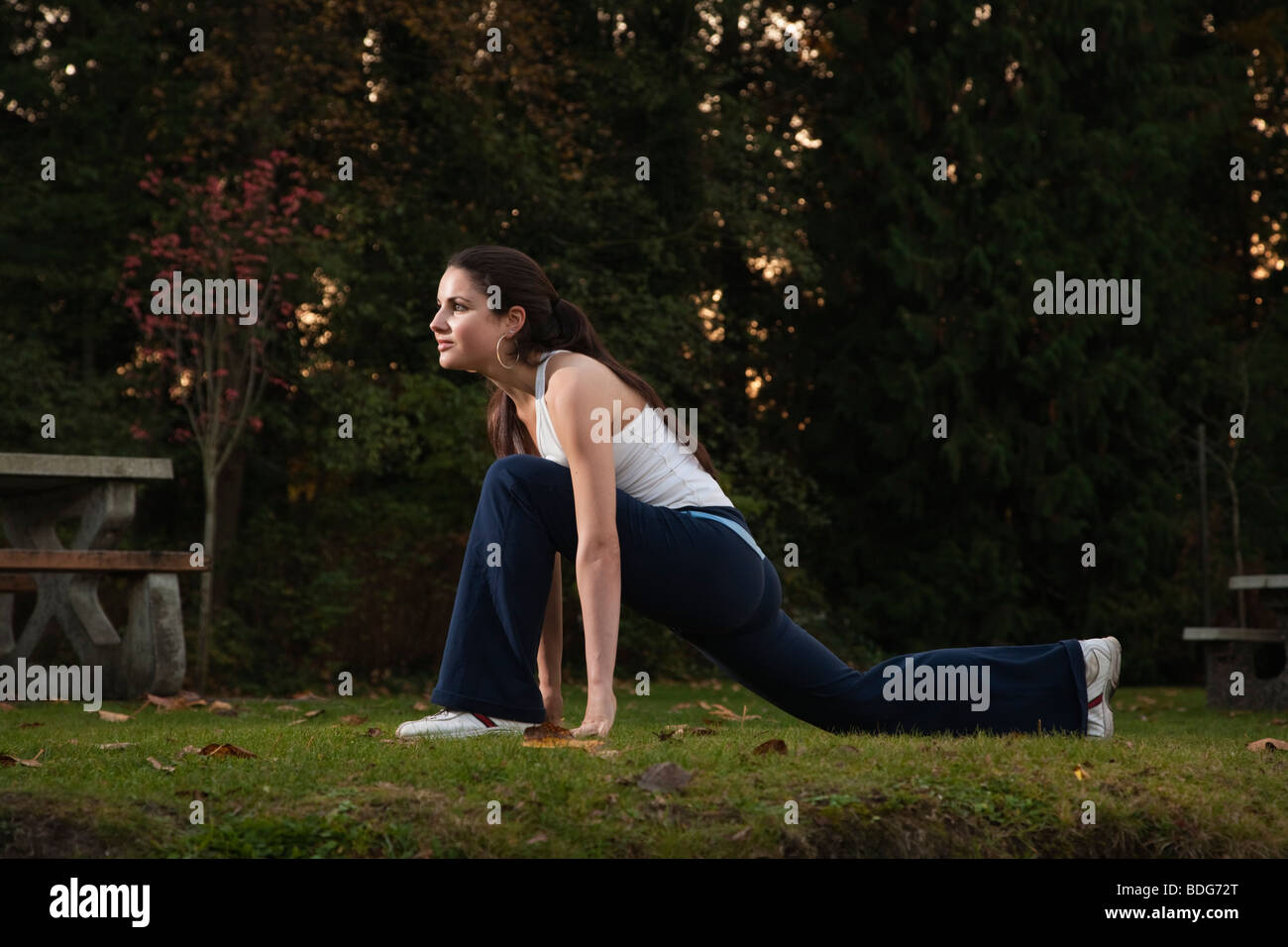 A young woman stretching in a park, Port Moody, Vancouver, British ...