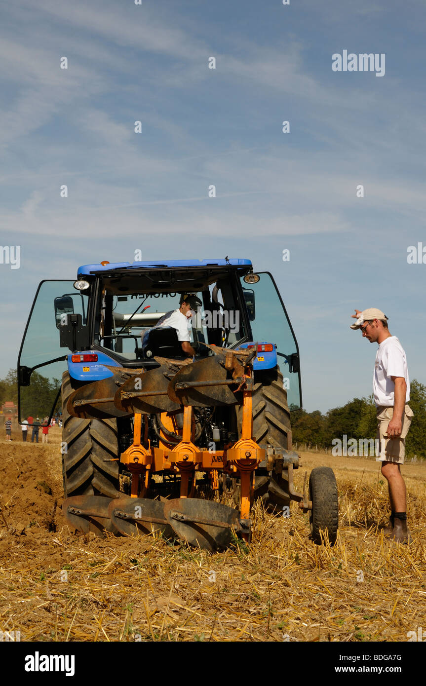 Stock photo of tractors ploughing fields in a farming competition in ...