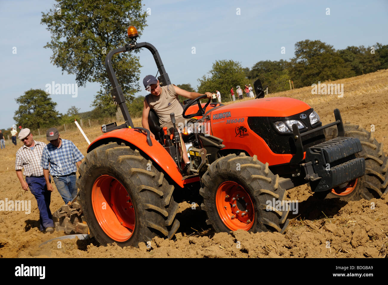 Stock photo of tractors ploughing fields in a farming competition in ...