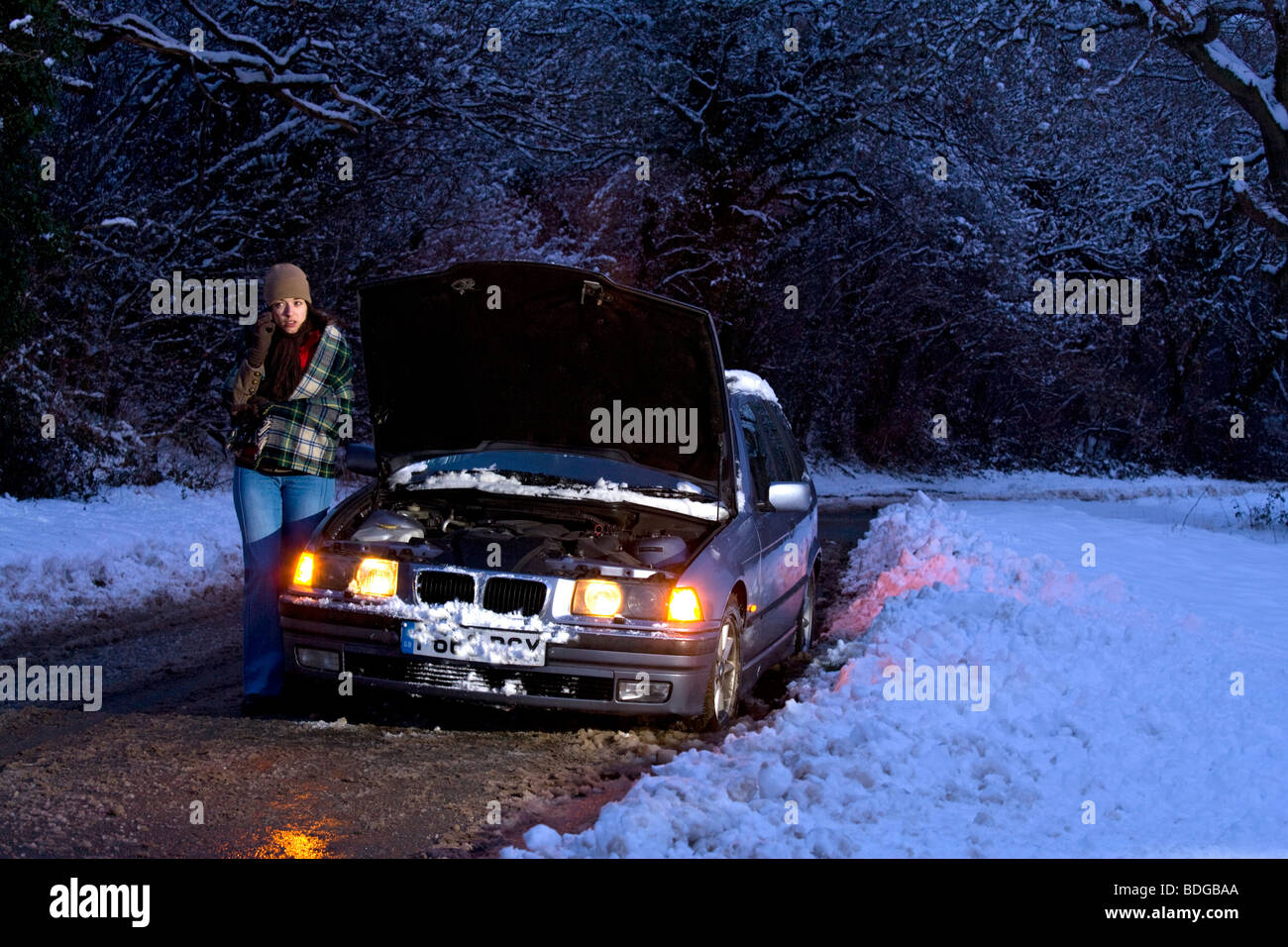 Women on her own broken down in the snow, stranded trying to get it ...