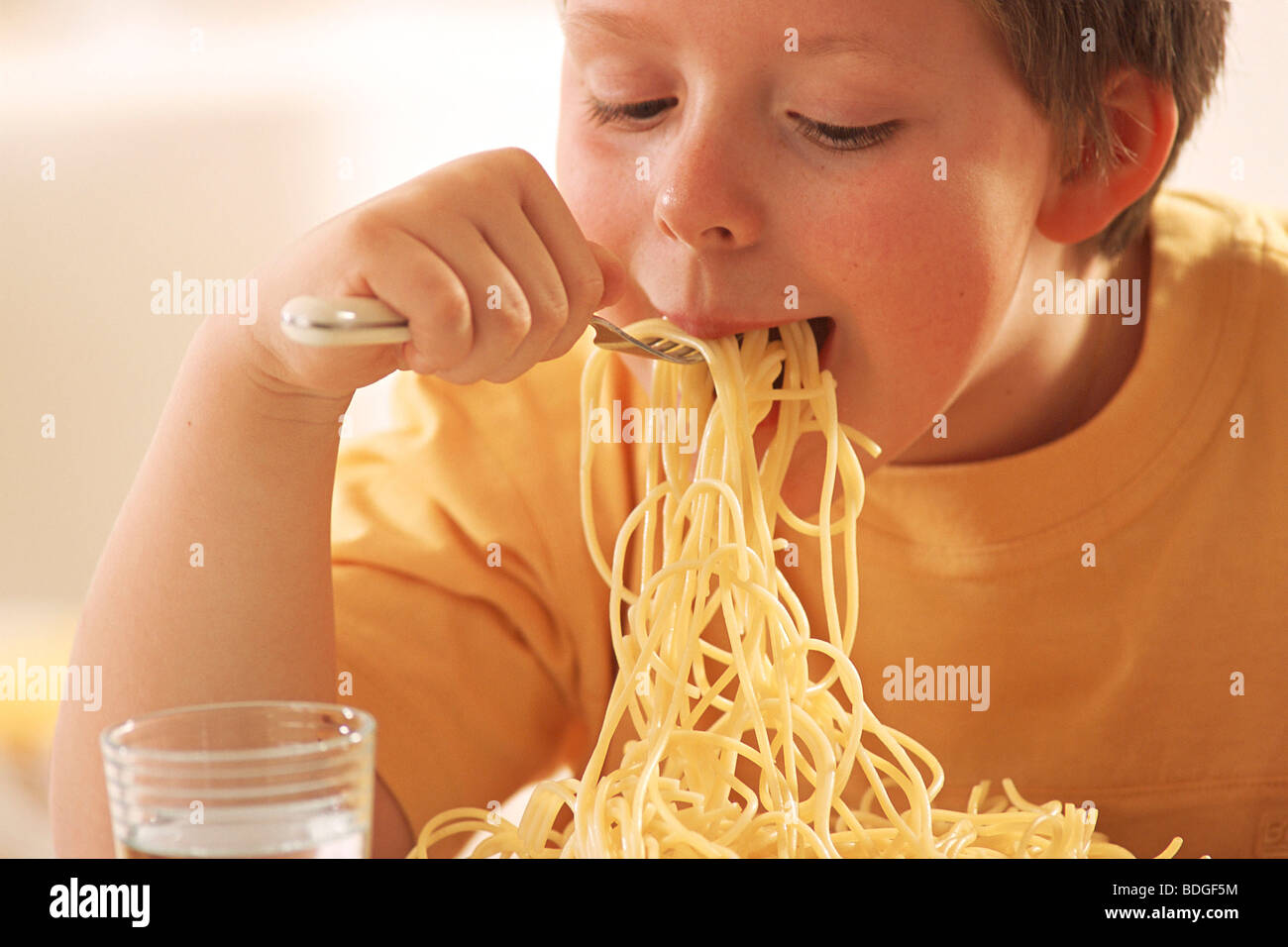 CHILD EATING STARCHY FOOD Stock Photo - Alamy