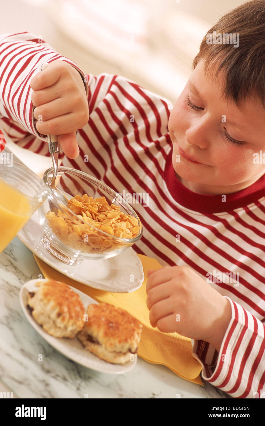 CHILD EATING BREAKFAST Stock Photo - Alamy