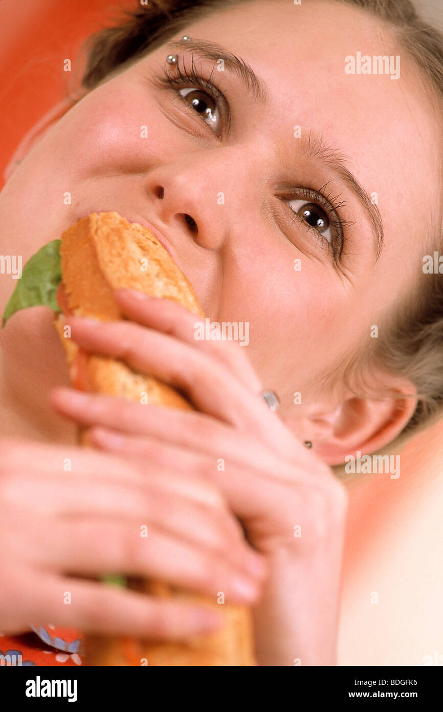 WOMAN EATING A SANDWICH Stock Photo - Alamy