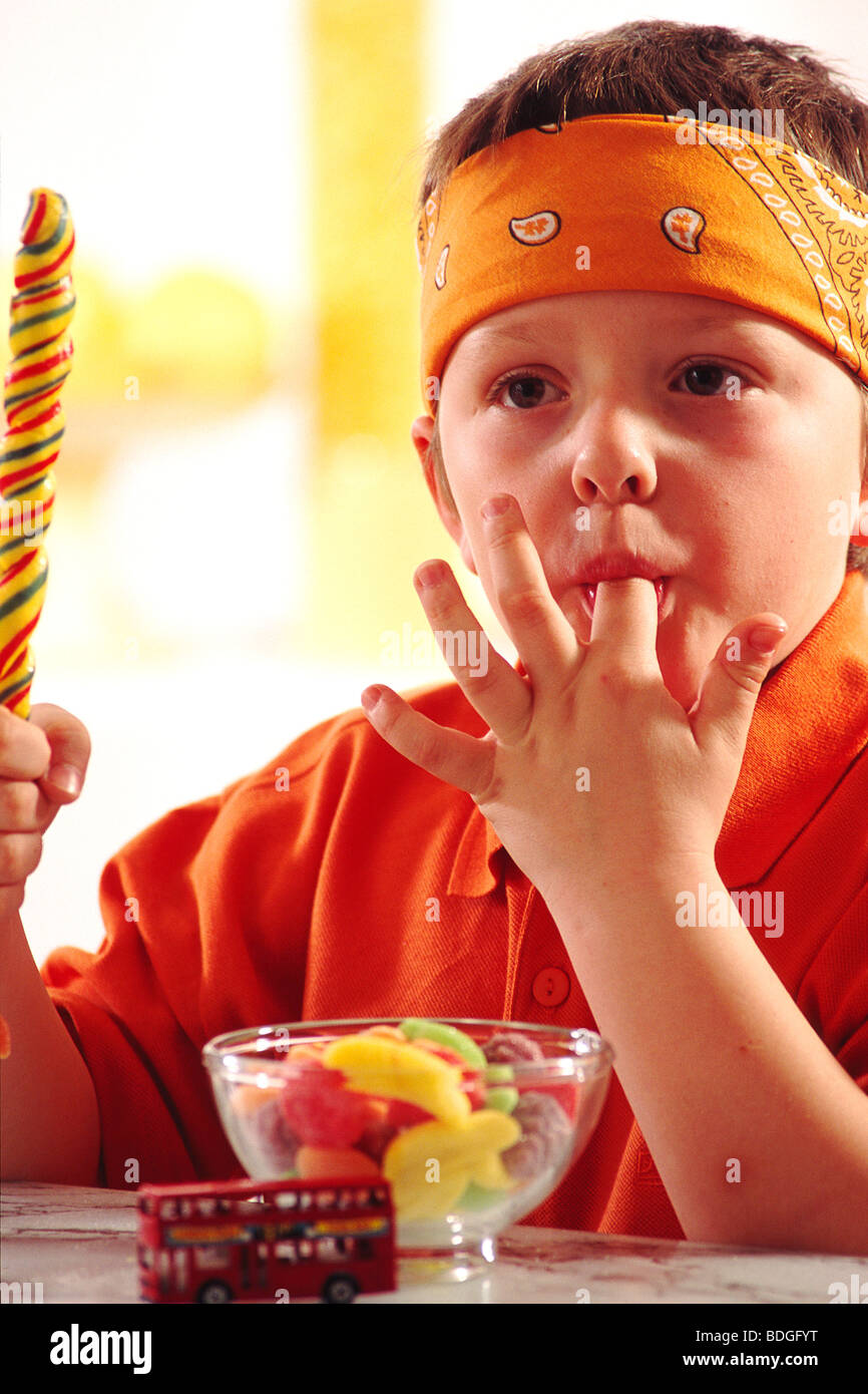 CHILD EATING SWEETS Stock Photo - Alamy