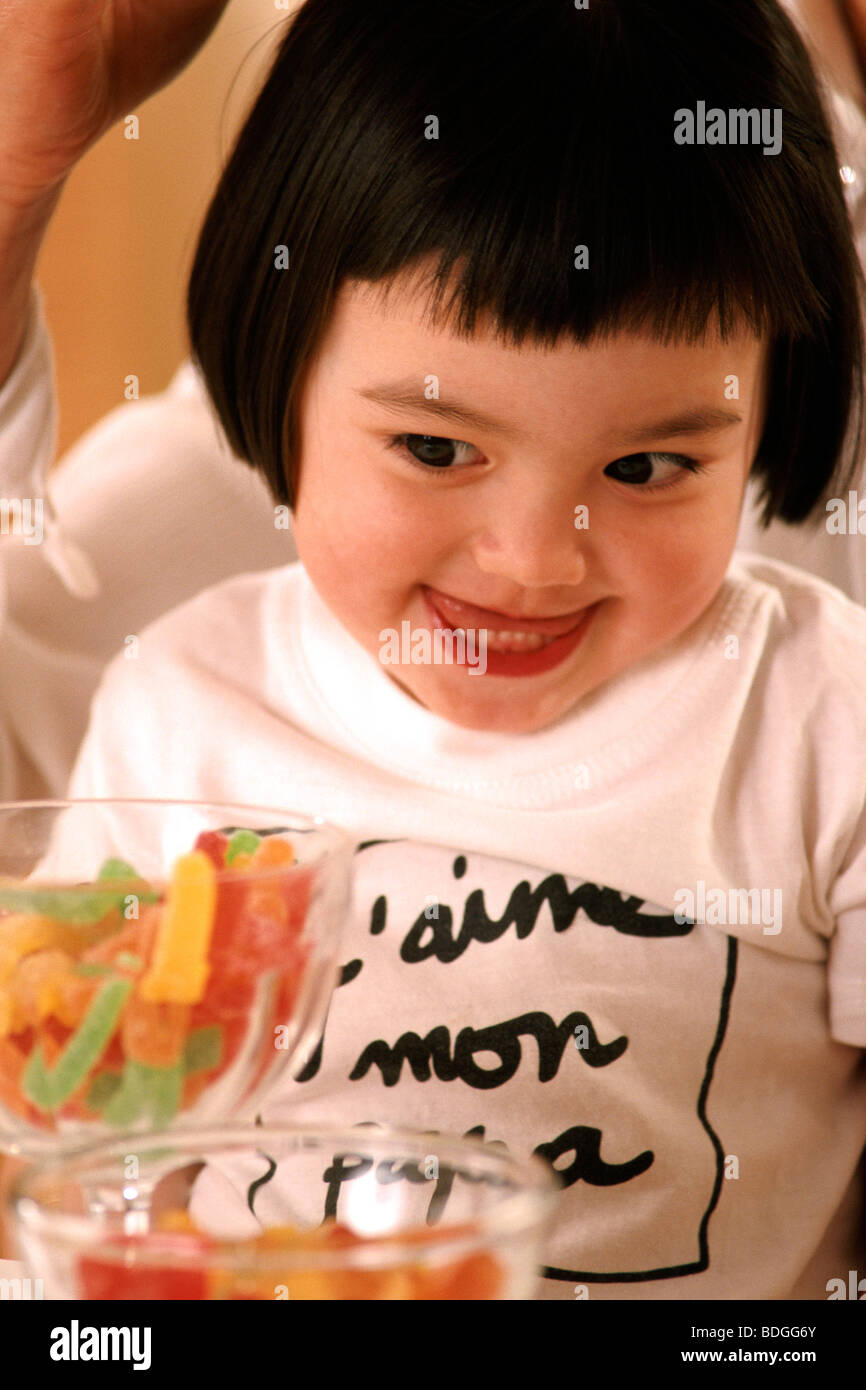 CHILD EATING SWEETS Stock Photo - Alamy
