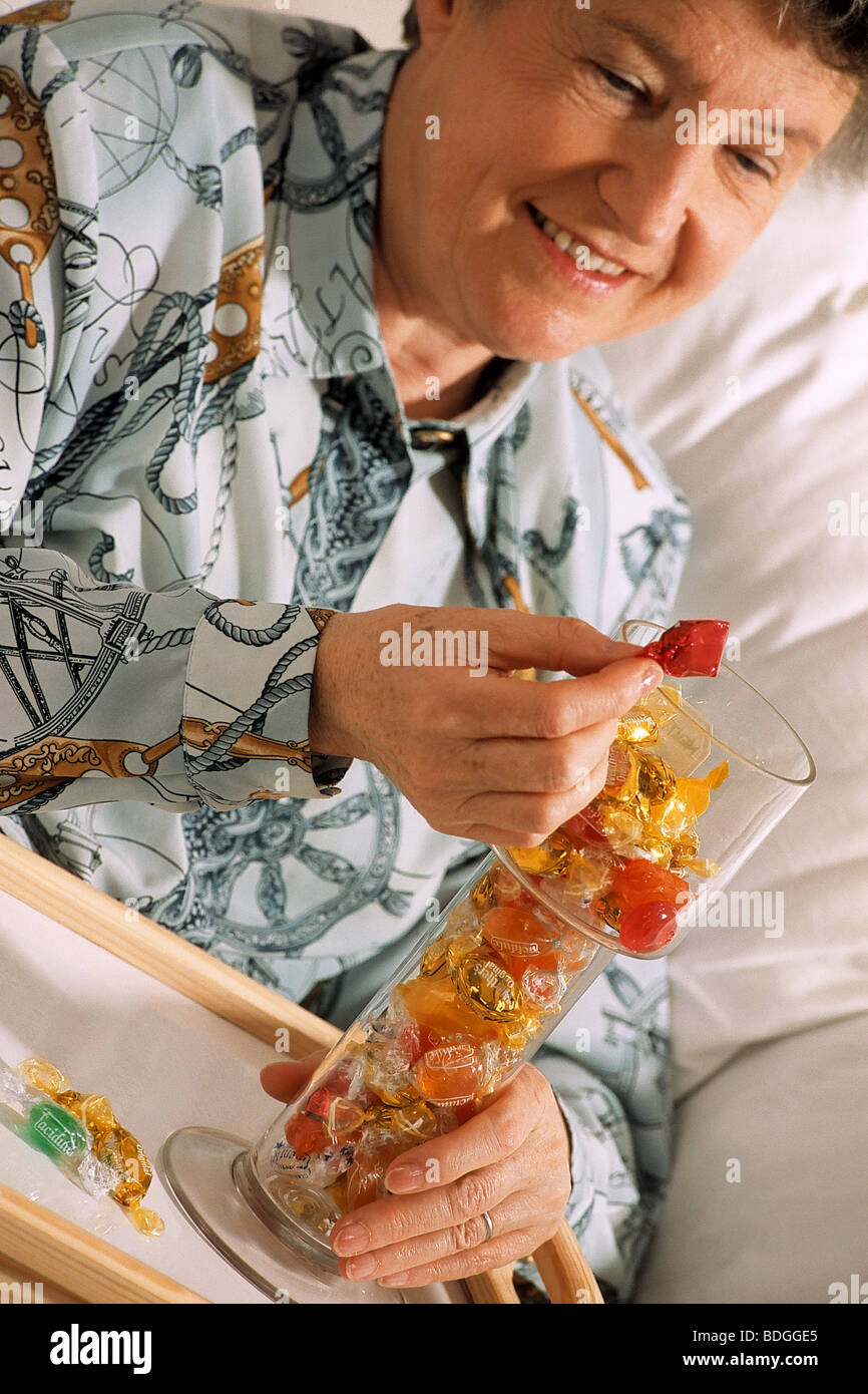 ELDERLY PERSON EATING SWEETS Stock Photo - Alamy