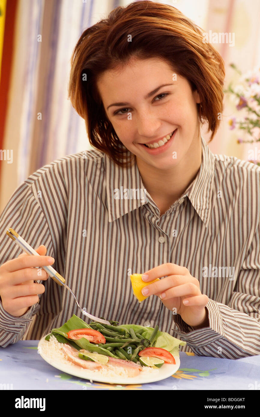 WOMAN EATING FISH Stock Photo - Alamy