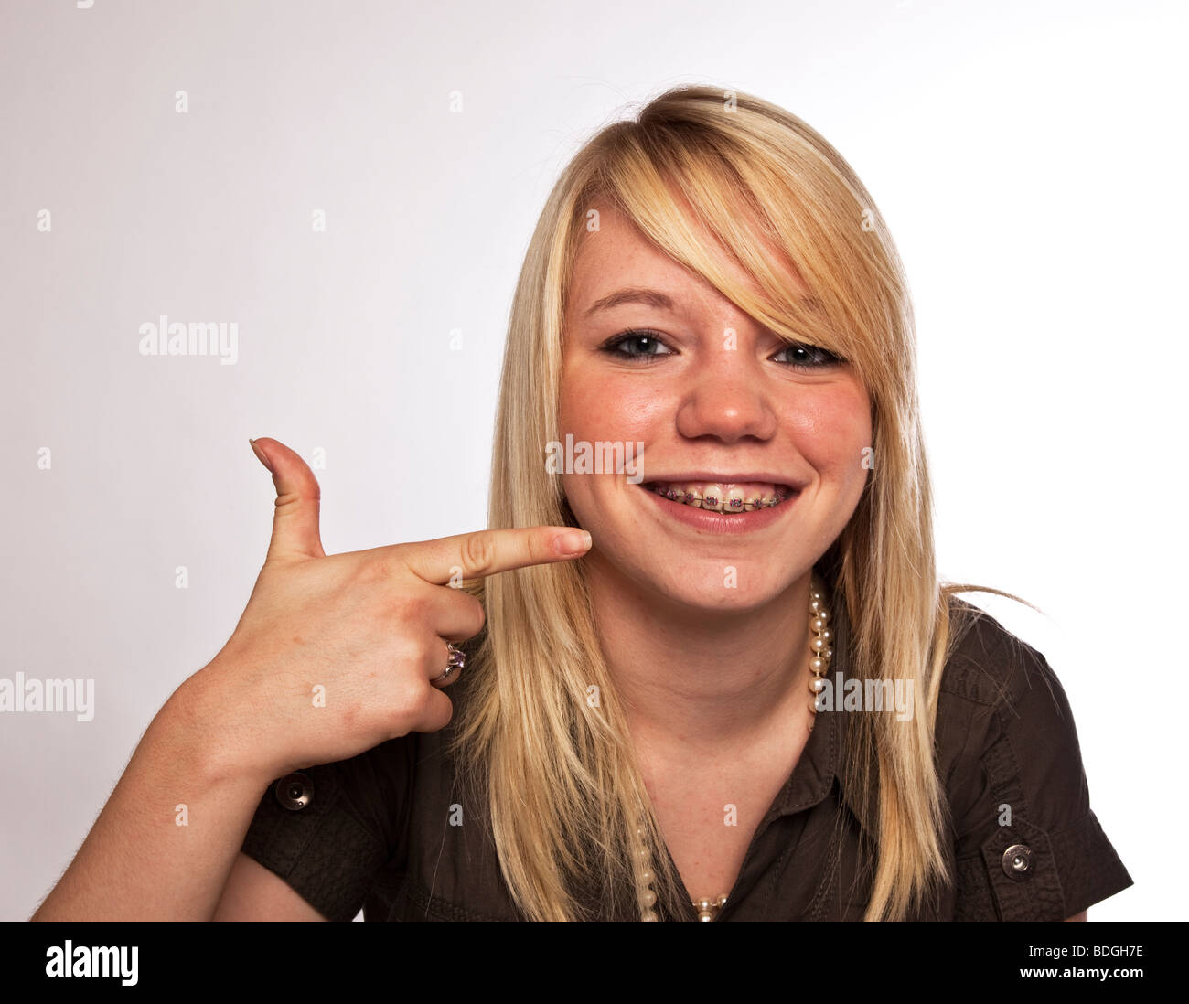 Young girl points out that teeth braces are cool Stock Photo - Alamy