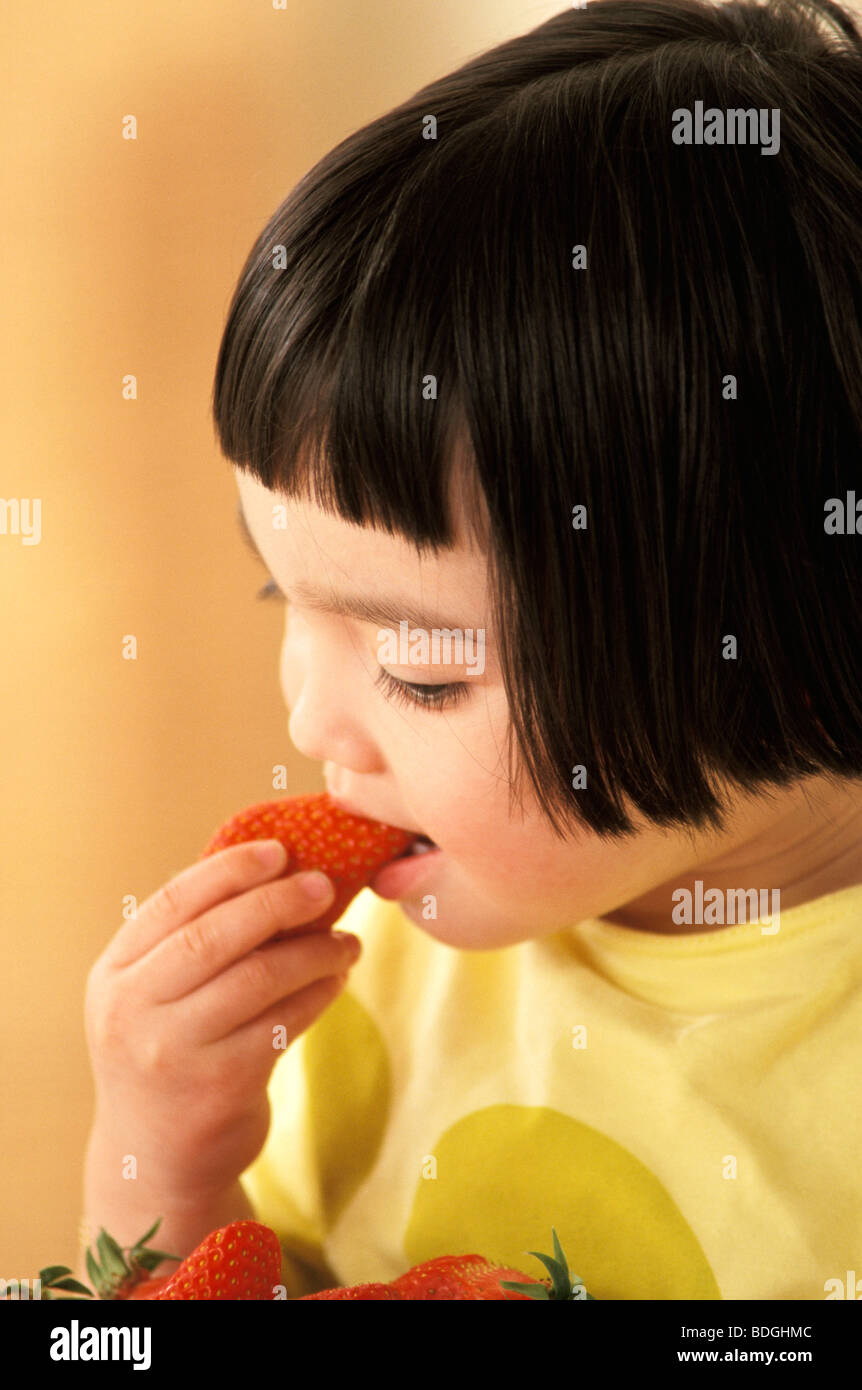 CHILD EATING FRUIT Stock Photo - Alamy