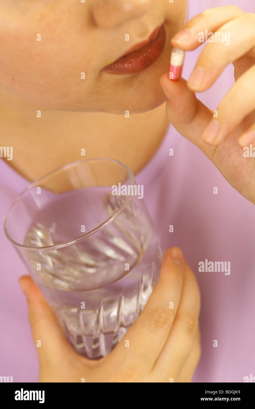 WOMAN TAKING MEDICATION Stock Photo - Alamy