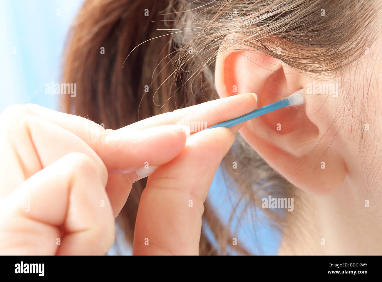 WOMAN CLEANING EARS Stock Photo - Alamy