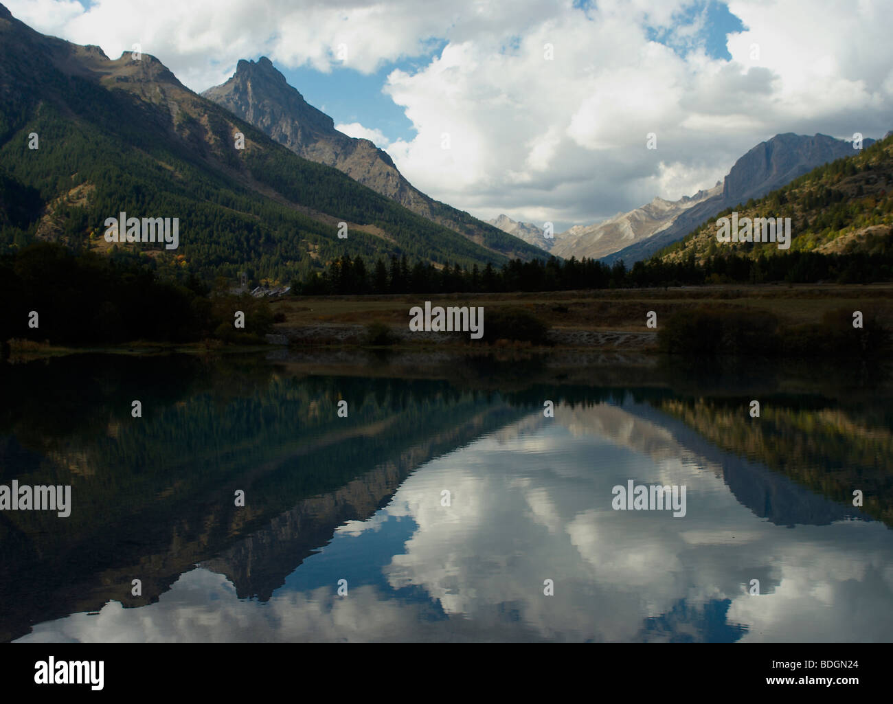 reflection of an Alpine mountain peak in a lake Stock Photo - Alamy