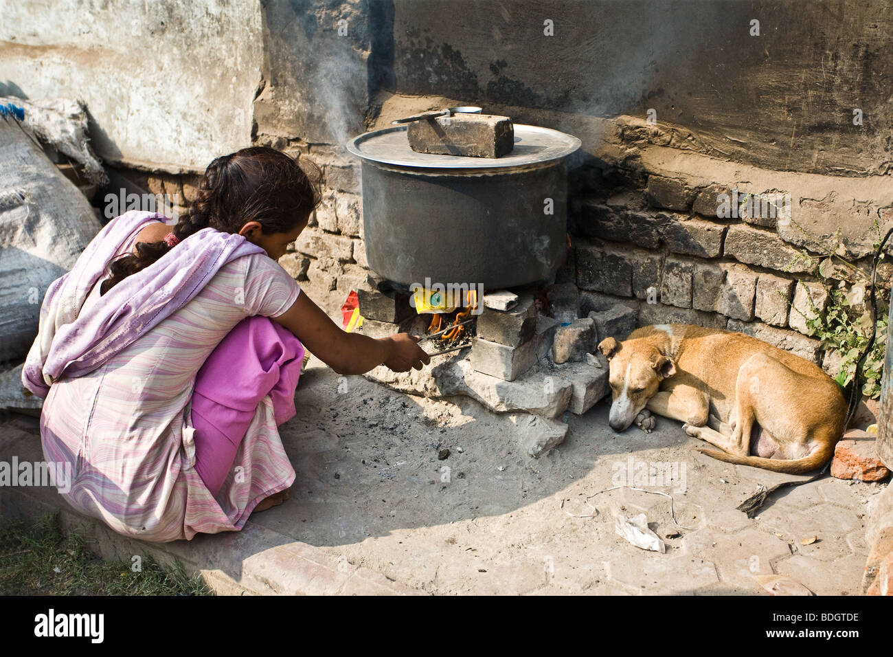 Girl cooking on coal fire. Typical rural cooking in India. Photo taken ...