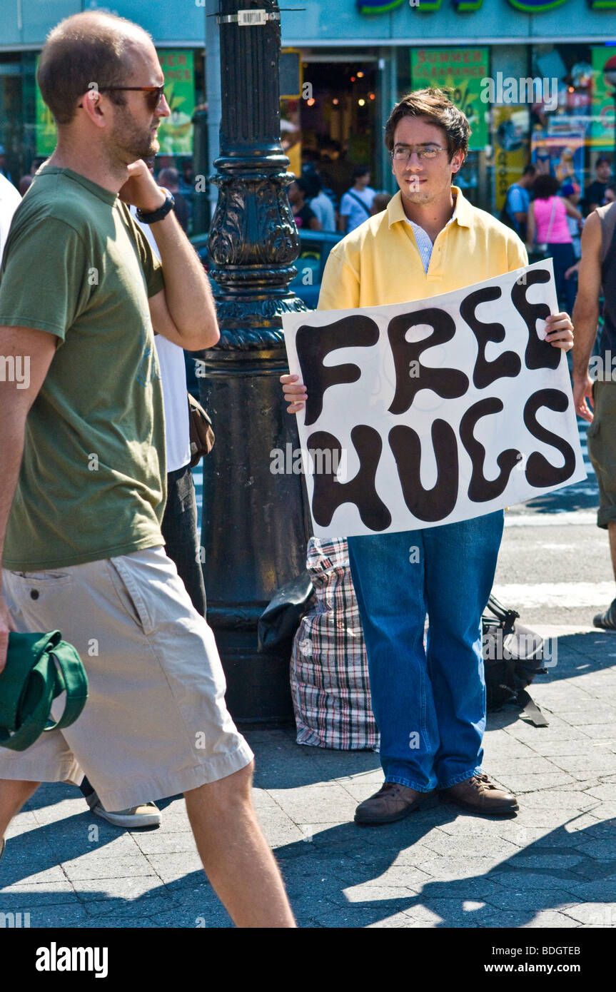 Group people offer free hugs to pedestrians Stock Photo - Alamy