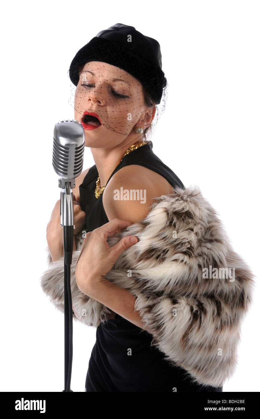 Retro singer singing into a retro microphone Stock Photo - Alamy