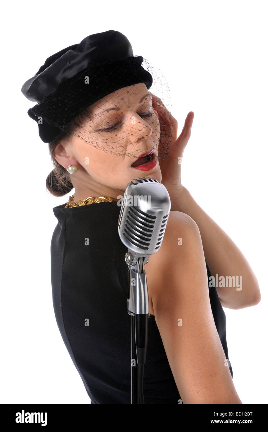 Retro singer singing into a vintage microphone Stock Photo - Alamy