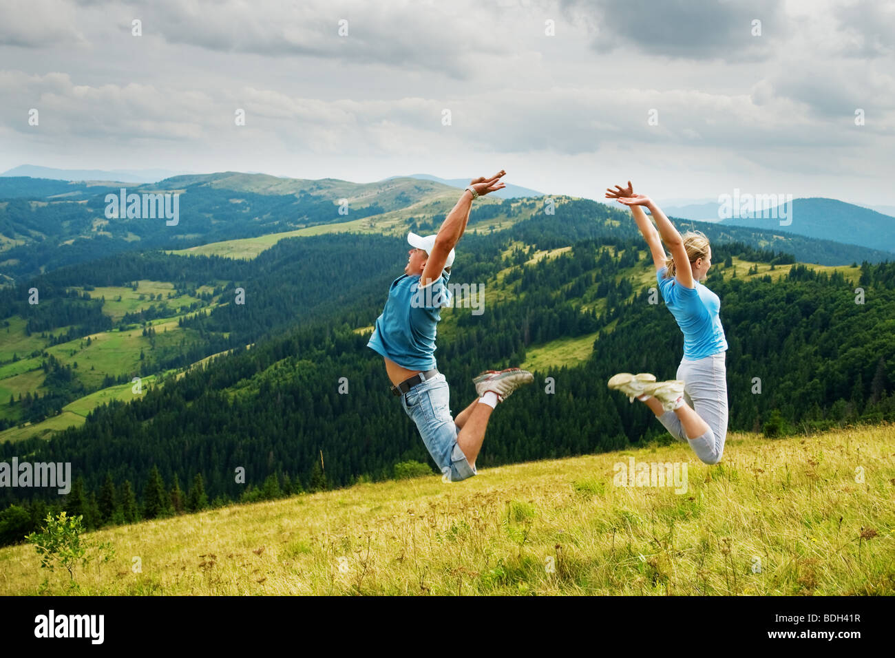 jumping couple in mountain Stock Photo - Alamy