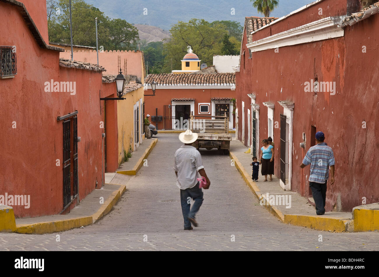 Side street with colorfully painted buildings in the town of Cosala ...