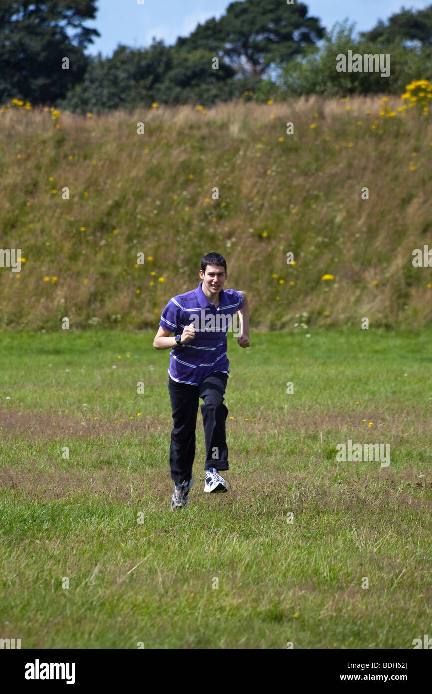 teenage boy running in Giant's Ring, Lagan valley, Belfast, Northern ...