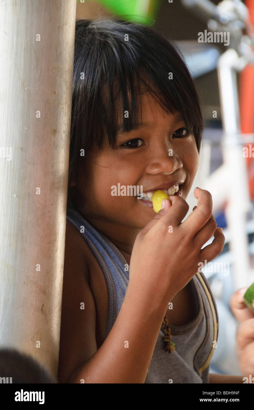 girl eating bitter fruit in Bangkok Thailand Stock Photo - Alamy