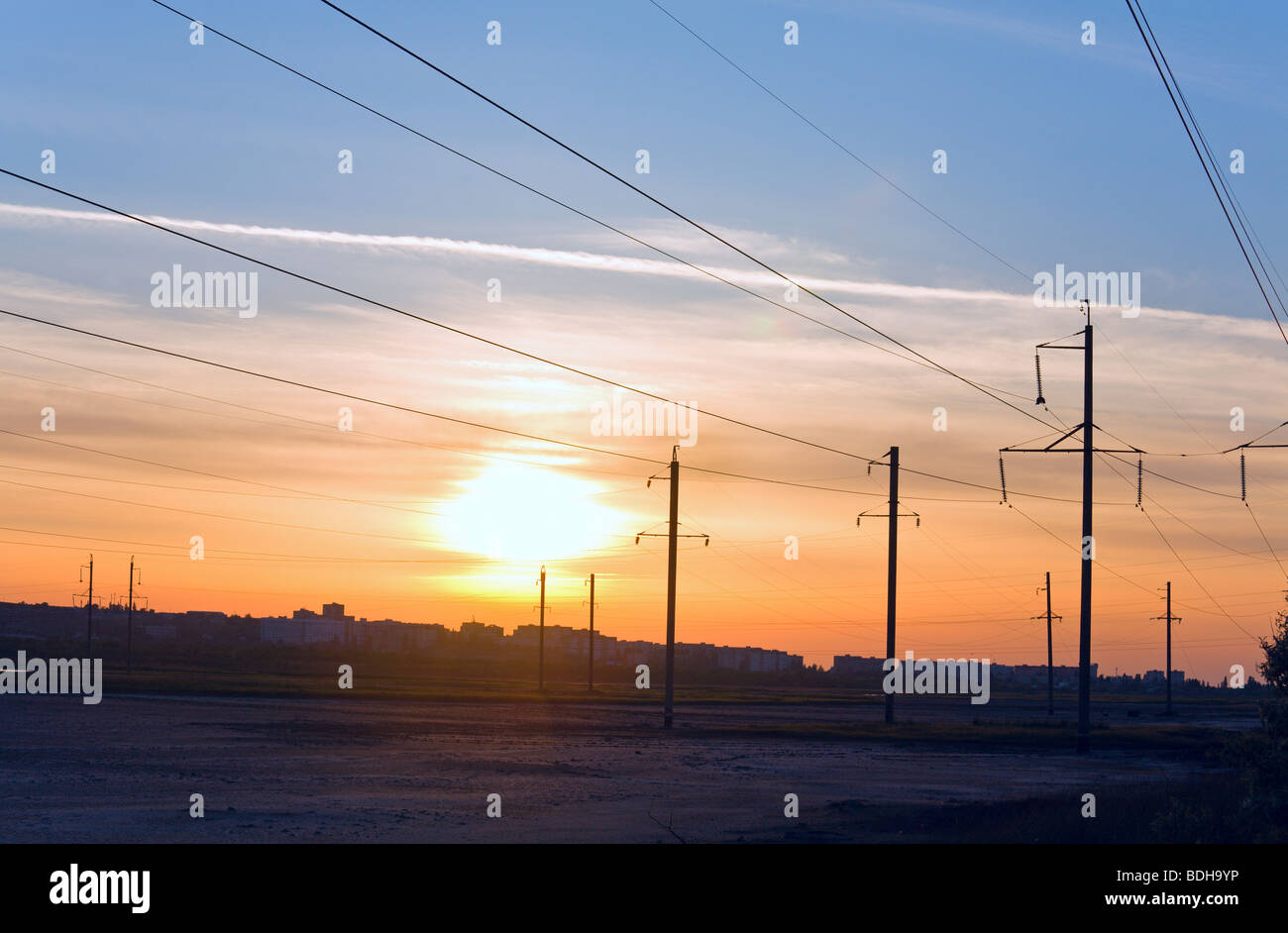 Sunset sky above the town and high-tension transmission line Stock ...