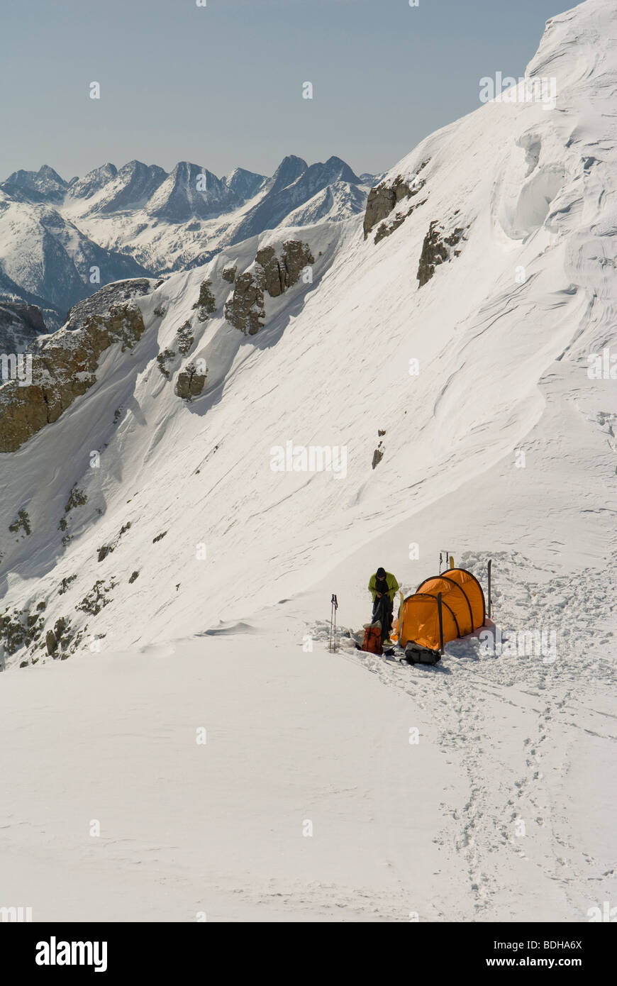 A man camping on a high ridge line in the winter, San Juan National ...