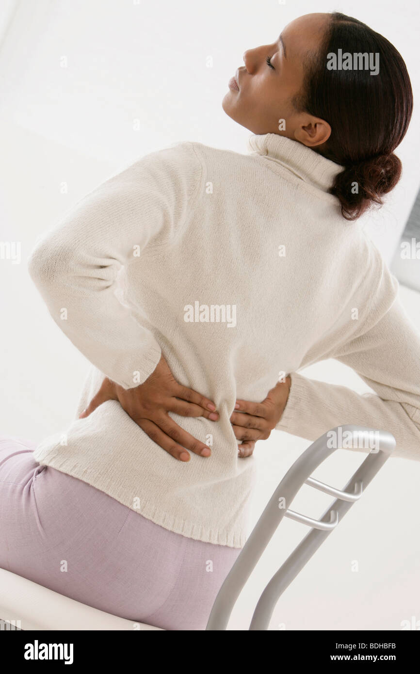 LOWER BACK PAIN IN A WOMAN Stock Photo - Alamy