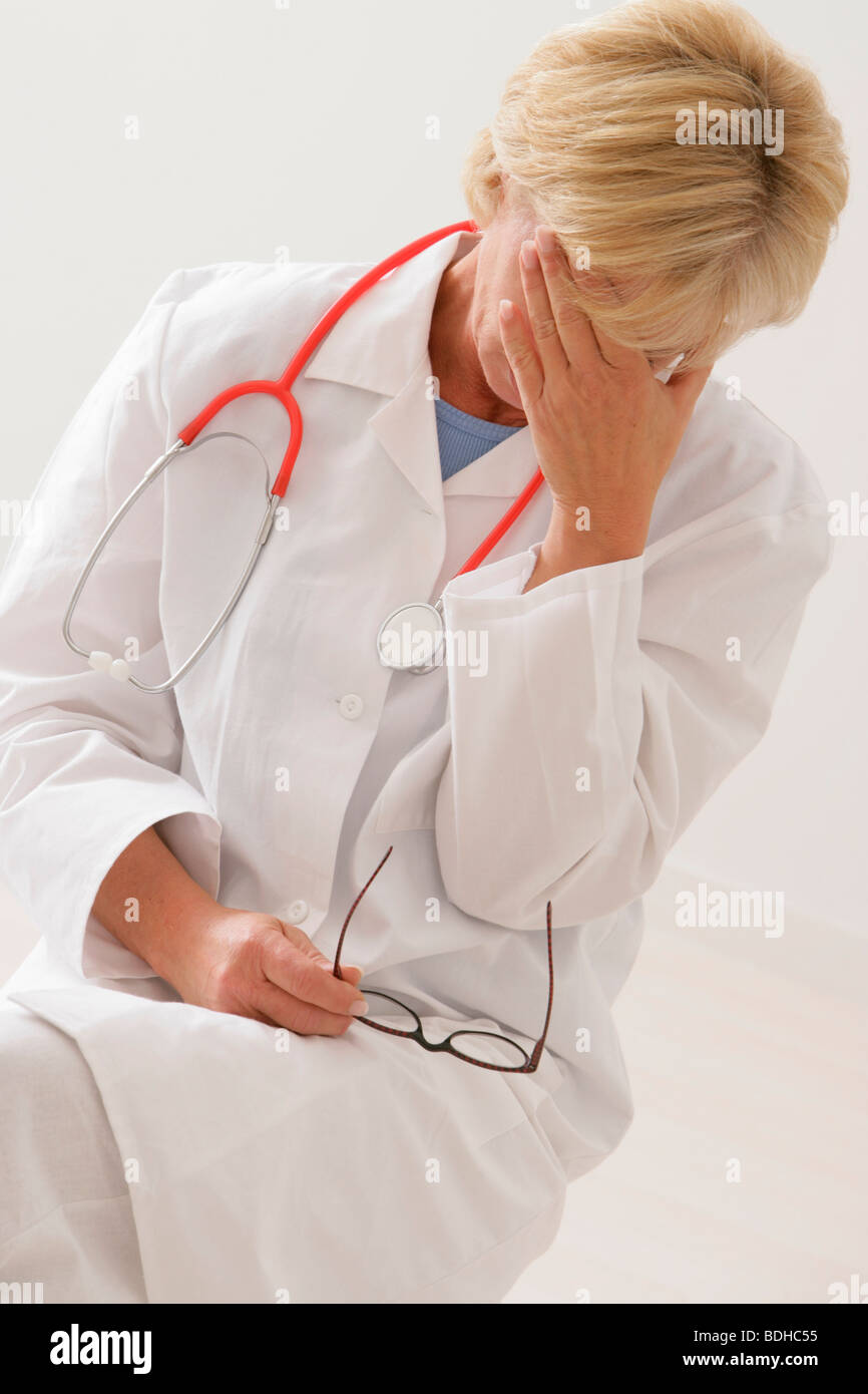 Overworked tired female doctor sits hi-res stock photography and images ...