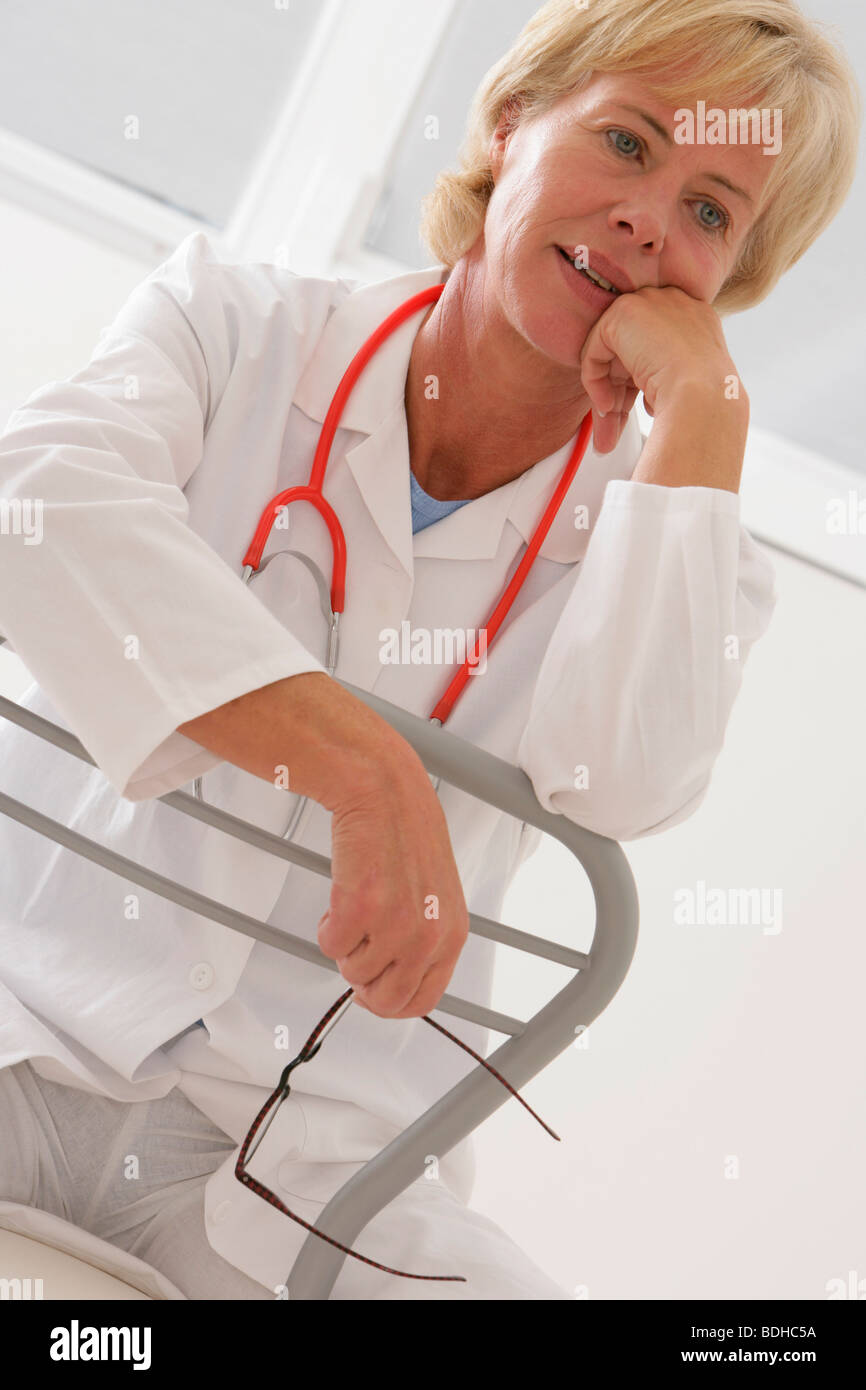 Overworked tired female doctor sits hi-res stock photography and images ...