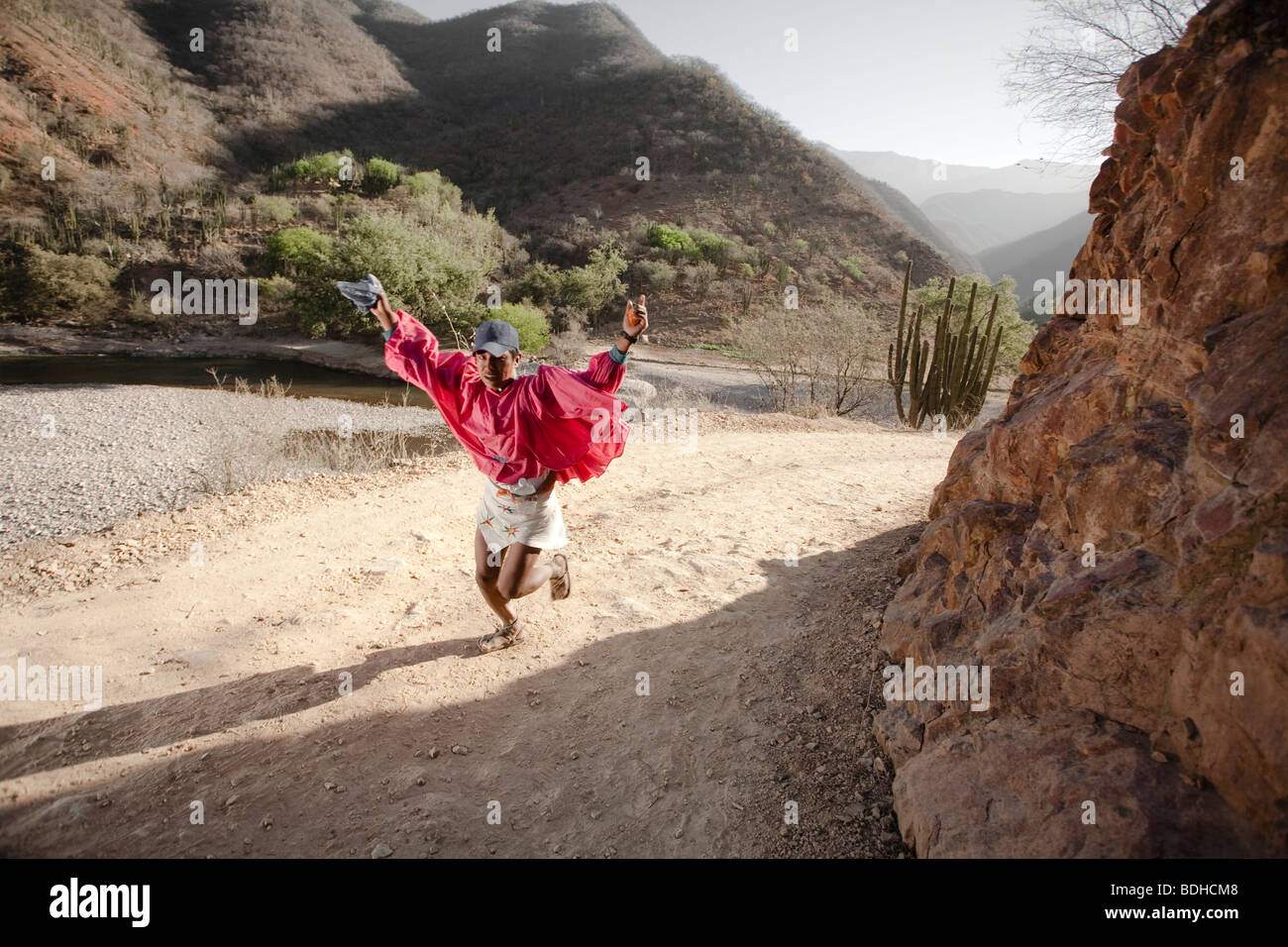 A Tarahumara runner running dressed with traditional clothes during an ...
