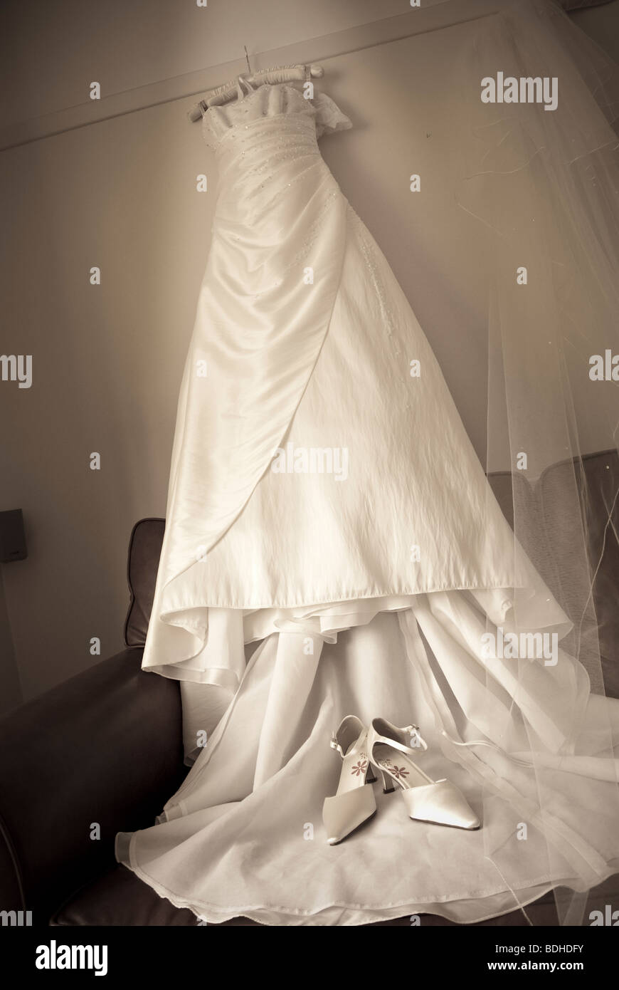 bridal gown hung on wall waiting for the bride to get ready Stock Photo ...