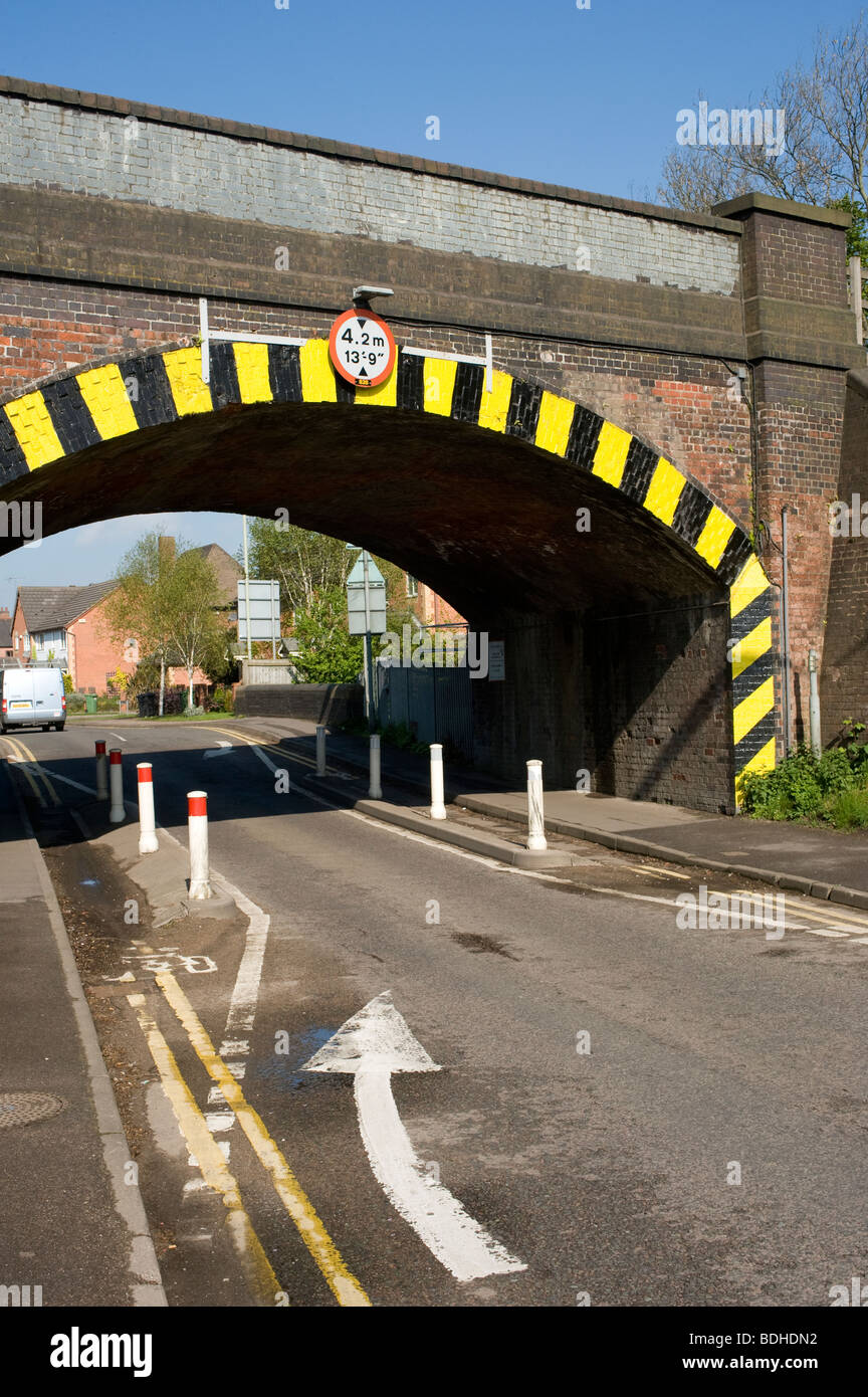 Road markings guiding traffic single file beneath a height restricted ...
