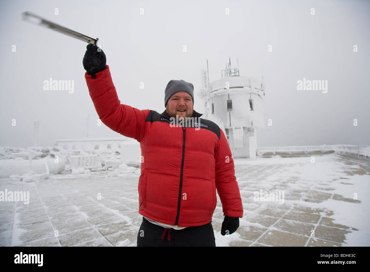 A weather observer on the summit of Mt. Washington holds an instrument ...