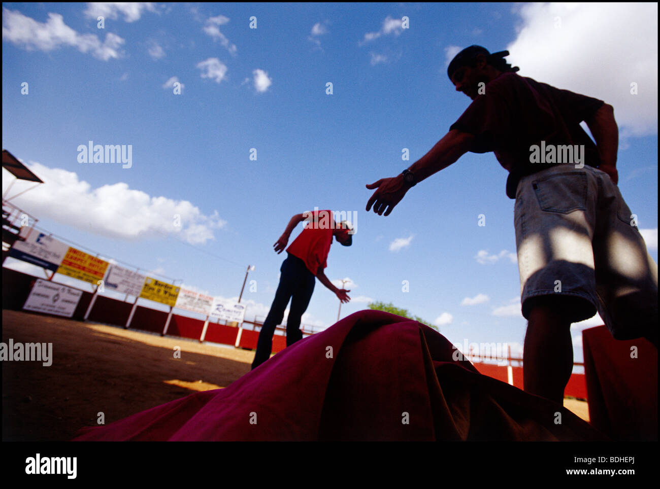 A matador teaching an aspiring bullfighter how to properly Stock Photo ...