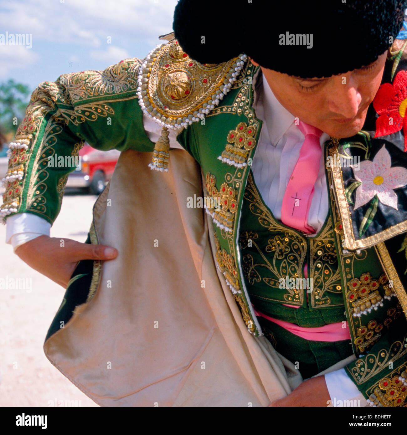 A matador wraps himself in his parade cape prior to entering the Santa ...