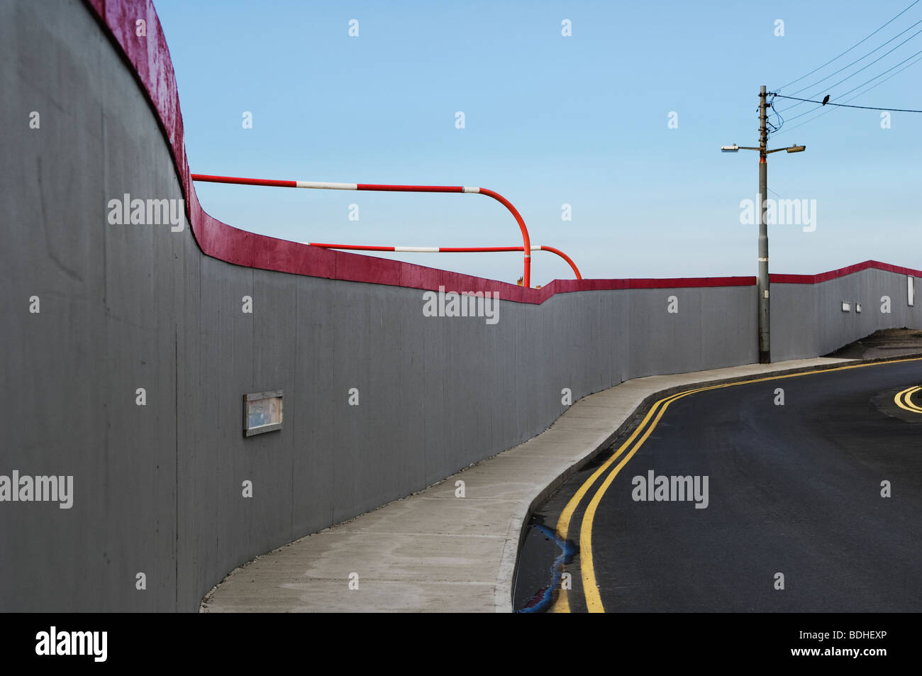 Construction site boarding along a winding road Stock Photo - Alamy