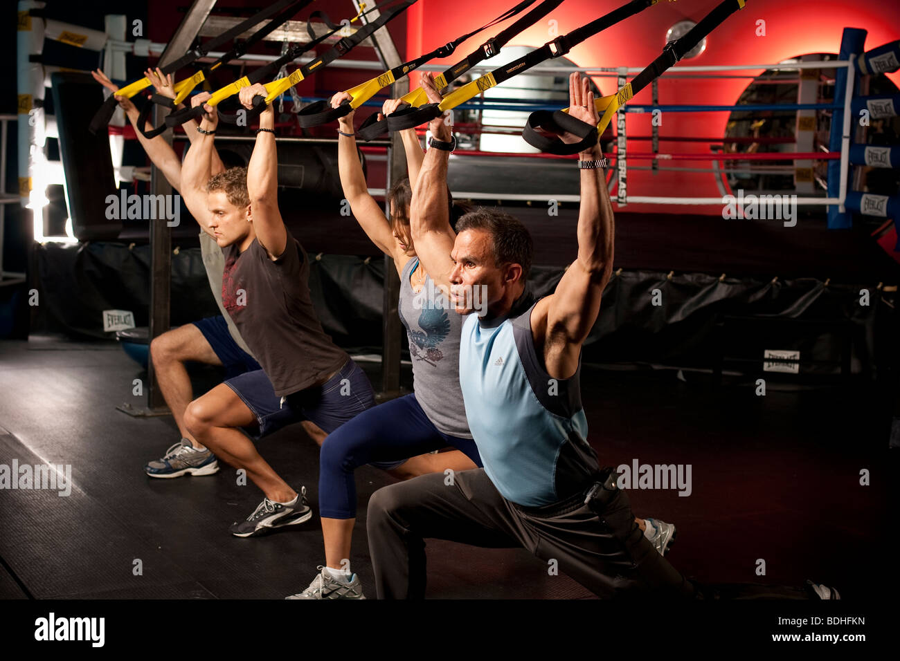 A group of people working out on the TRX suspension trainer, at Crunch ...