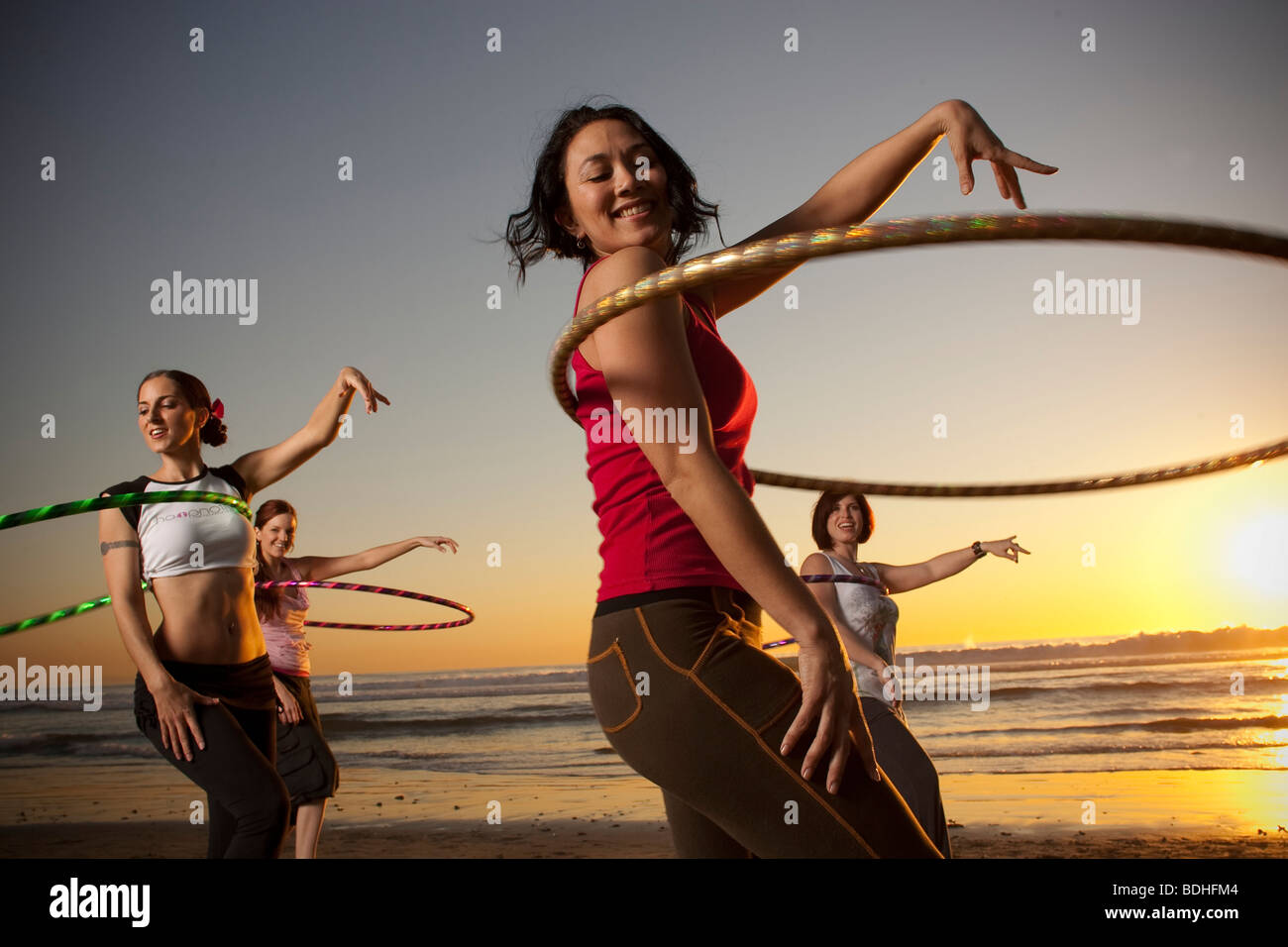 A group of people exercise with hula- hoops on the beach, Marina Del ...
