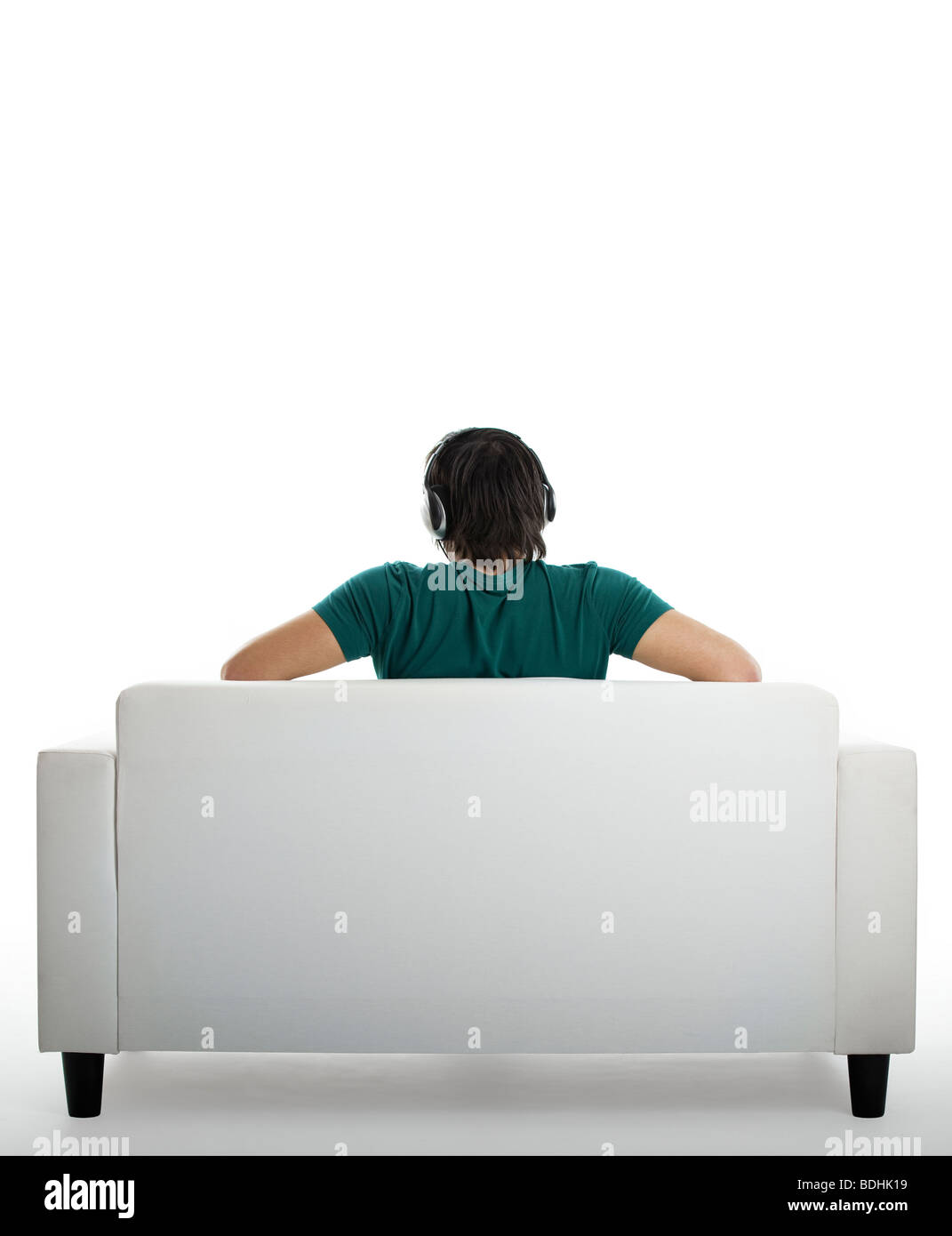 Back view from a young man seated on the couch Stock Photo - Alamy