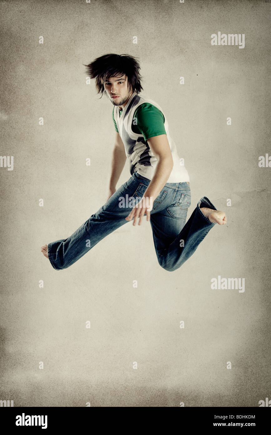 Young modern man jumping over grunge background Stock Photo - Alamy